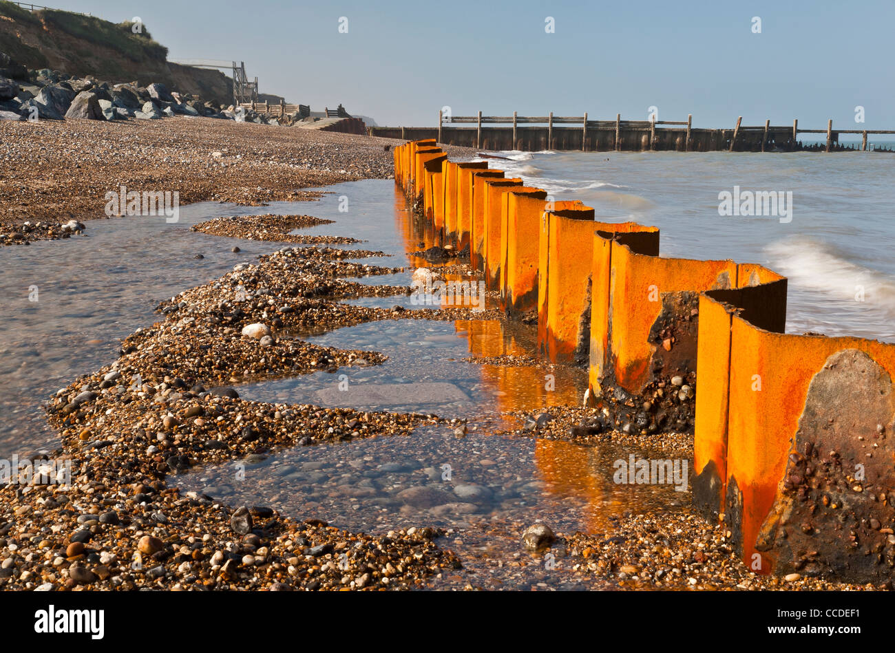 Wood, Rock and Metal Sea defenses and metal steps from beach onto cliff ...