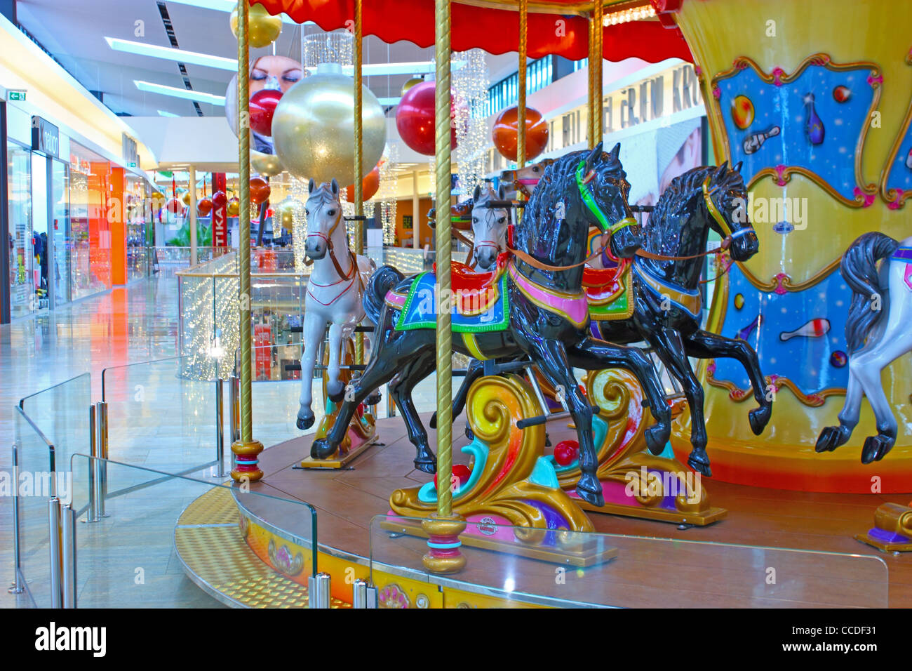 Merry-go-round, child attraction in shopping mall Stock Photo - Alamy