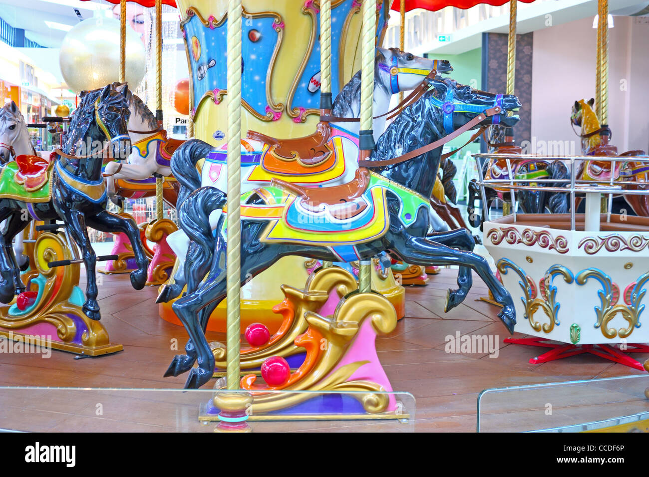 Merry-go-round, child attraction in shopping mall Stock Photo - Alamy