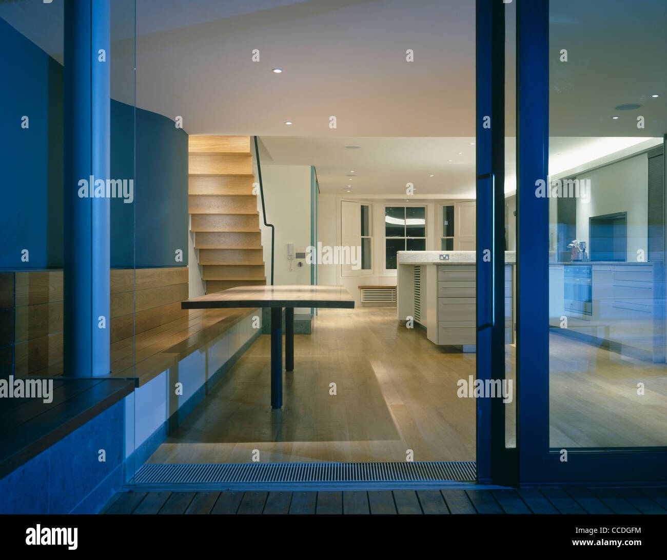 HOUSE EXTENSION LOOKING IN AT NIGHT THROUGH SLIDING DOORS Stock Photo ...