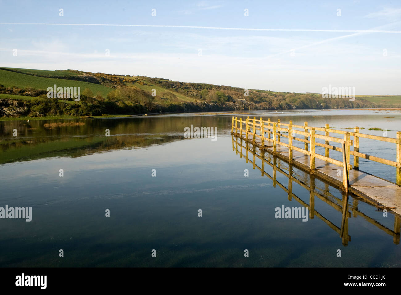 A walkway which is partially submerged by the incoming tide on the ...