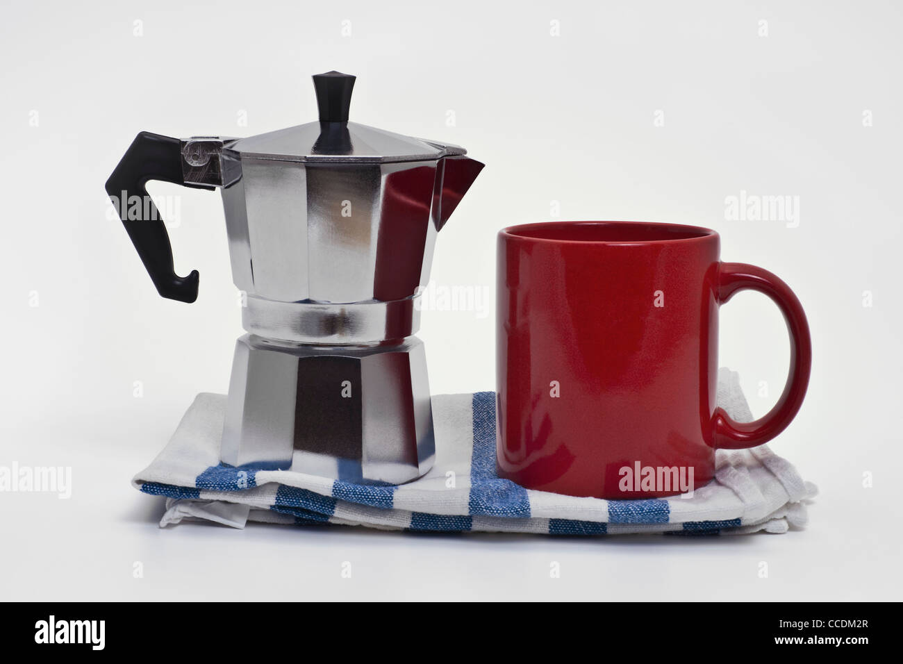 Detail photo of a simple coffee maker, percolator, and a cup upright on ...