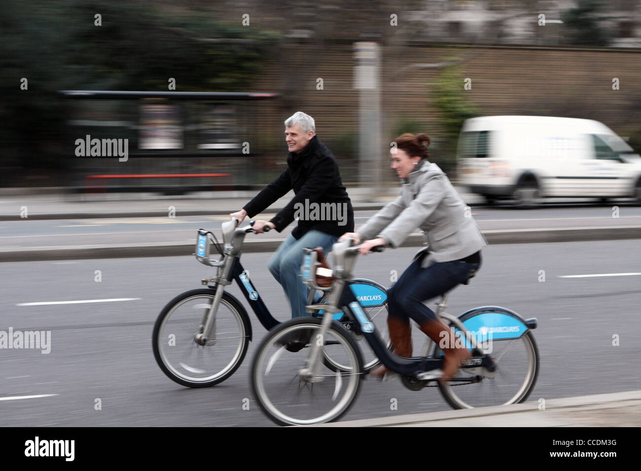 a male and female riding Boris Bikes in London Stock Photo - Alamy