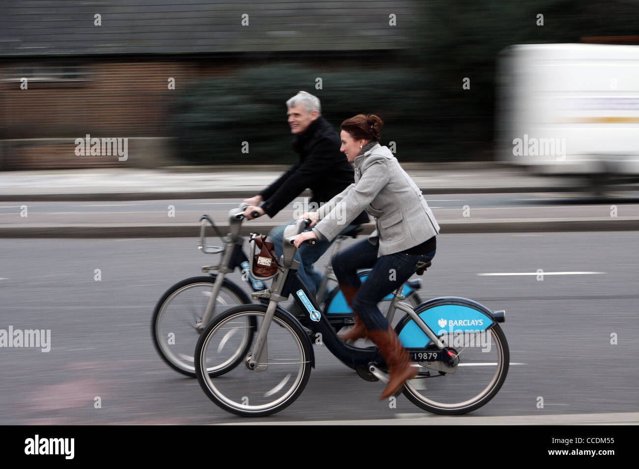 a male and female riding Boris Bikes in London Stock Photo - Alamy