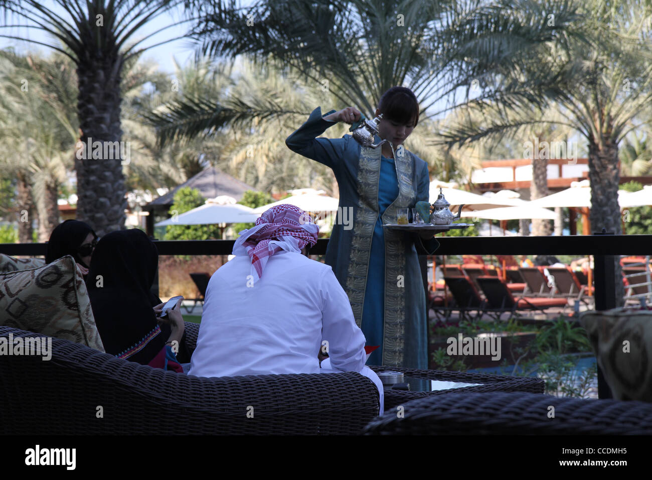 Teatime in Dubai - waitress serving tea to an Emirati family in ...