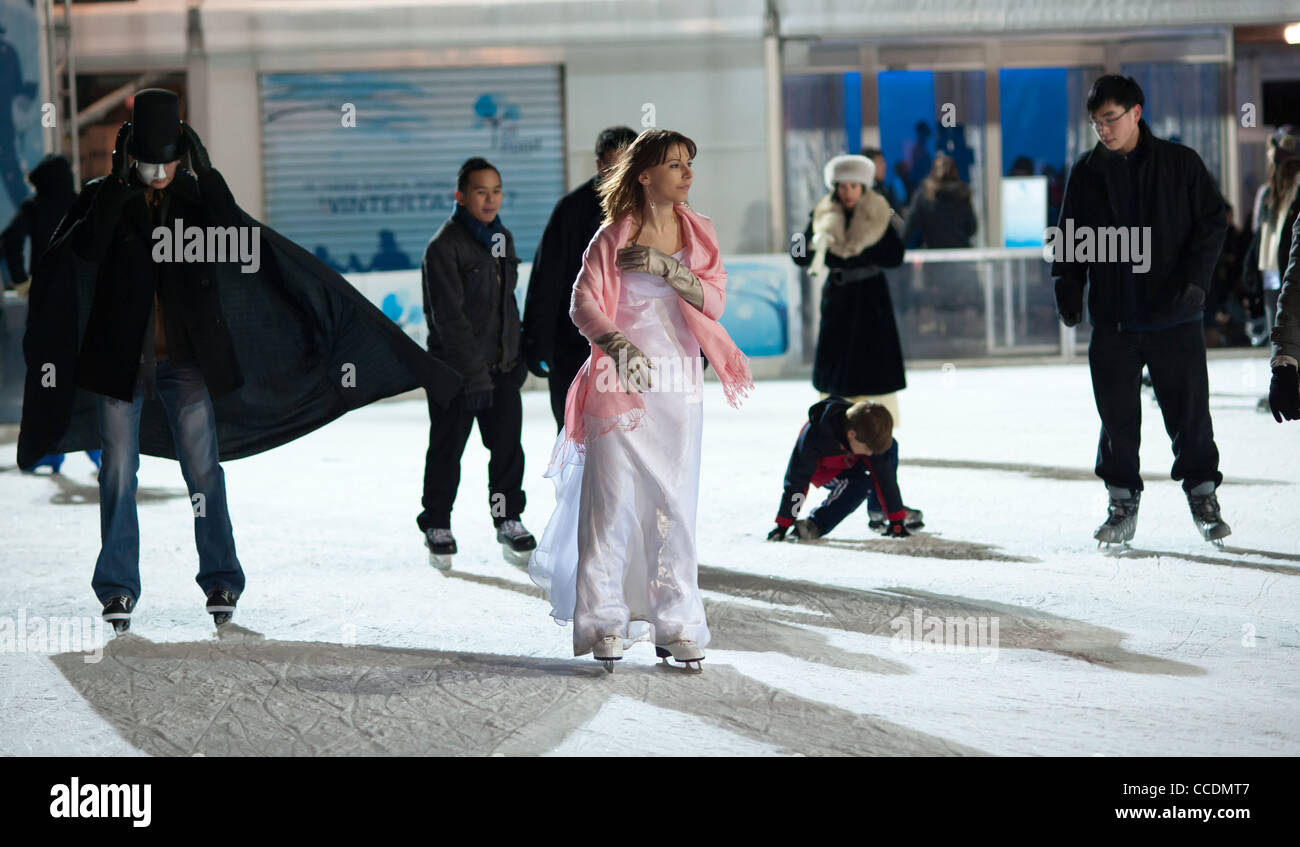 Skaters dressed in formal attire maneuver the packed Pond at Bryant ...