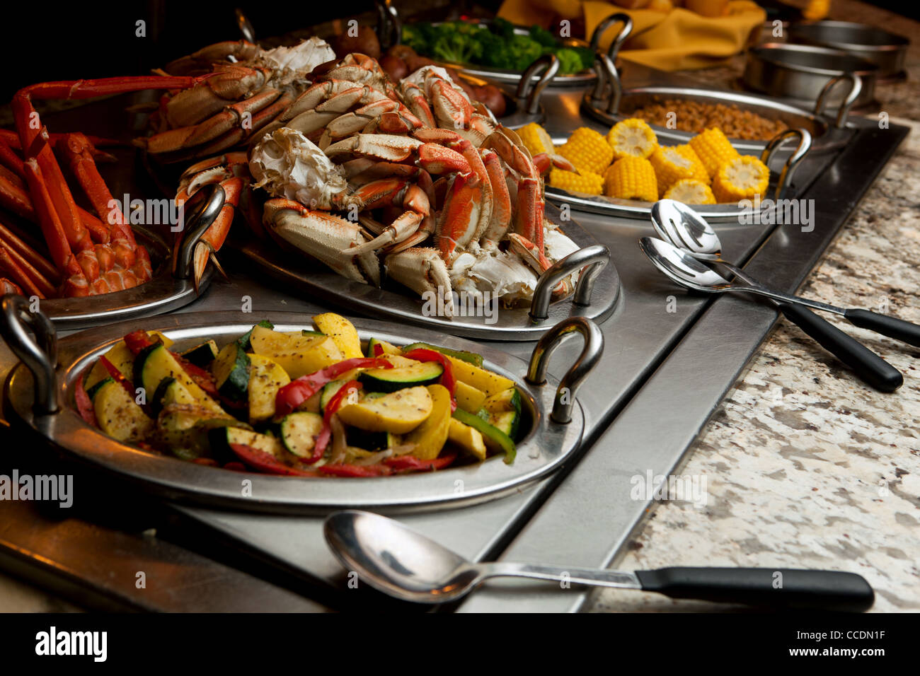 A classy buffet line at a resort's restaurant has crab legs as well as ...