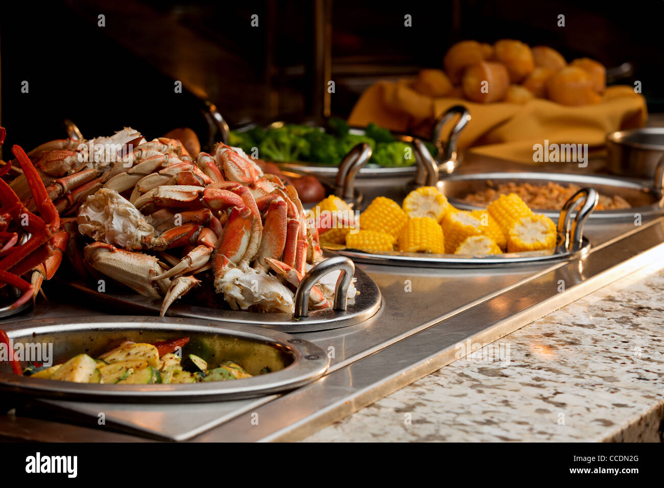 A classy buffet line at a resort's restaurant has crab legs as well as ...