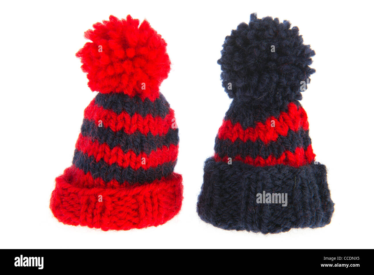 Red and blue knitted winter bonnets isolated over white background ...