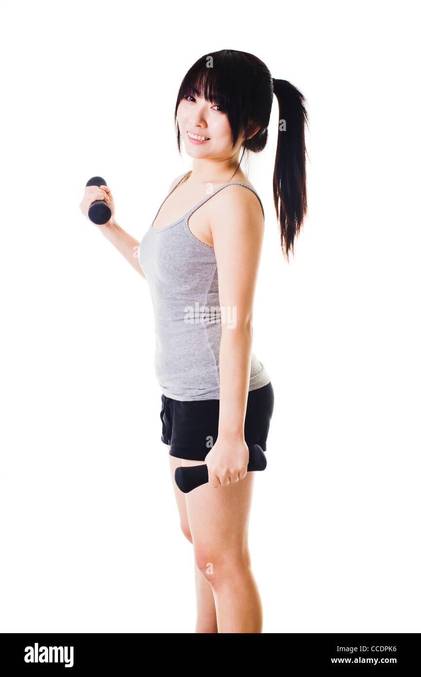 Chinese woman doing bicep curls with small hand weights Stock Photo - Alamy