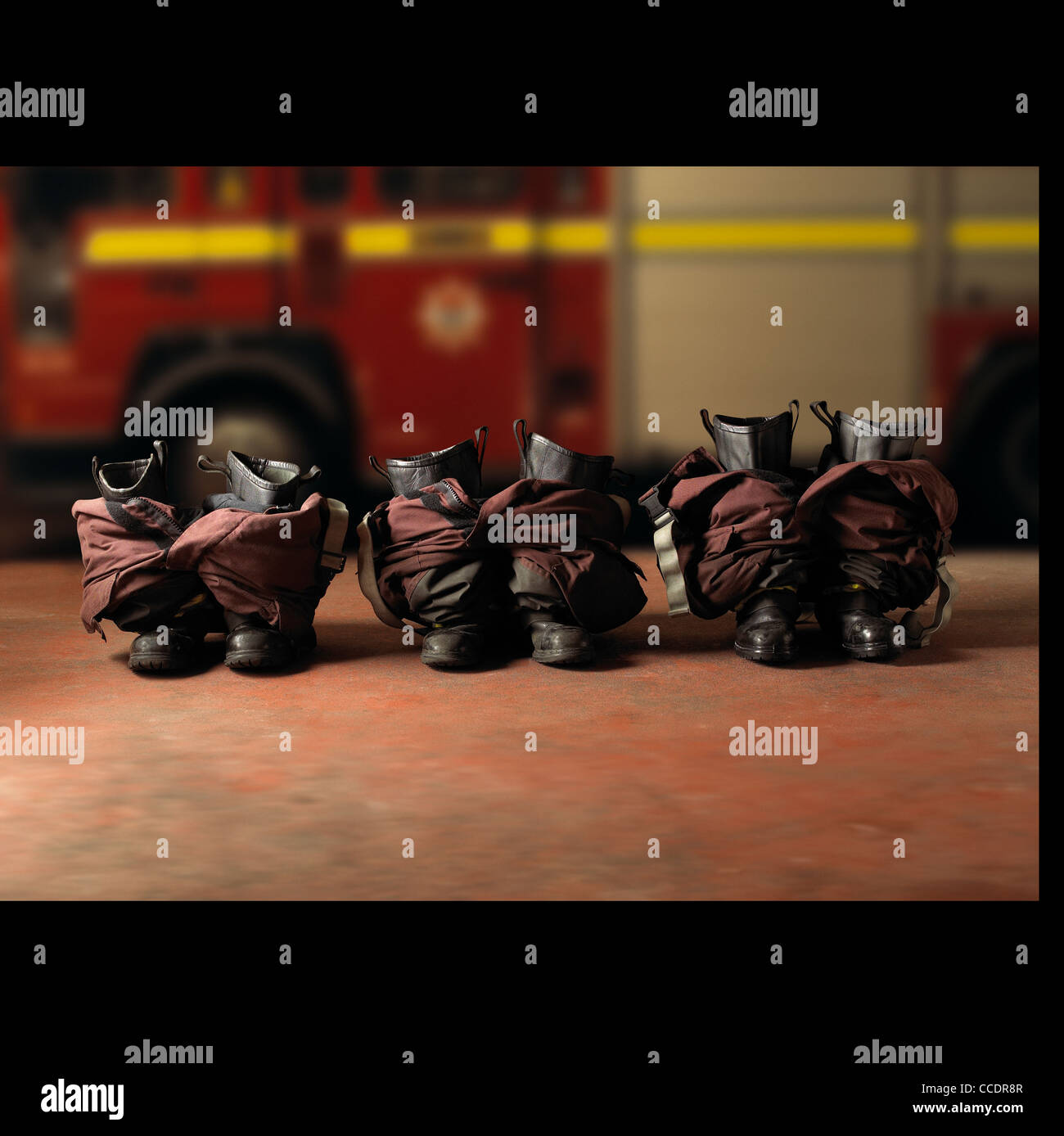 a row of fireman's boots with fire engine in the background Stock Photo ...