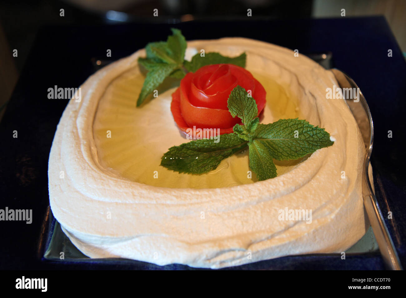 Display of a hummus plate, an Arab food dip or spread made from cooked ...