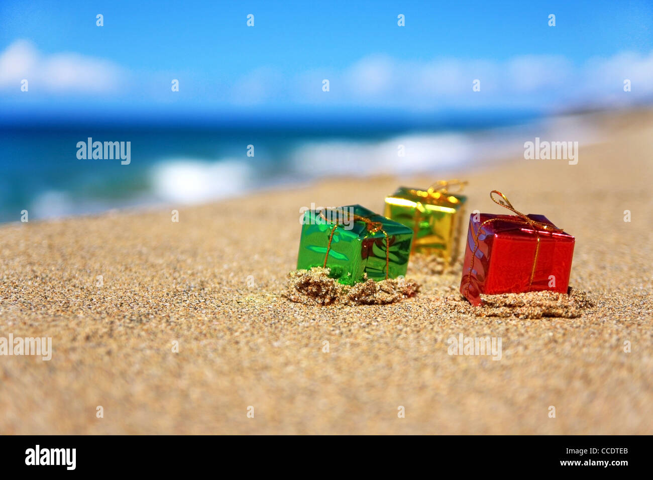 Christmas gift boxes on beach of ocean Stock Photo - Alamy