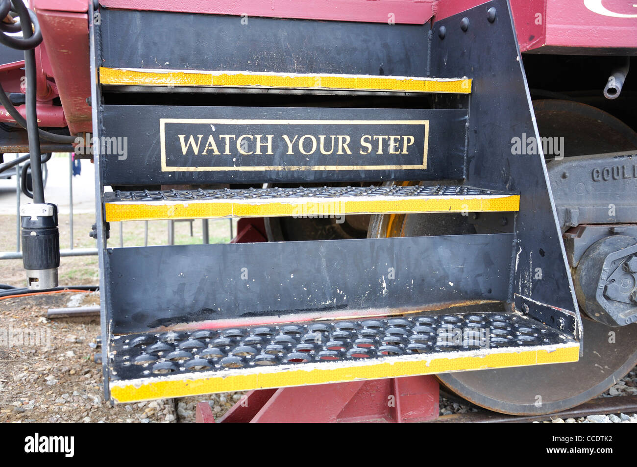 Watch your step sign on old train steps Stock Photo - Alamy