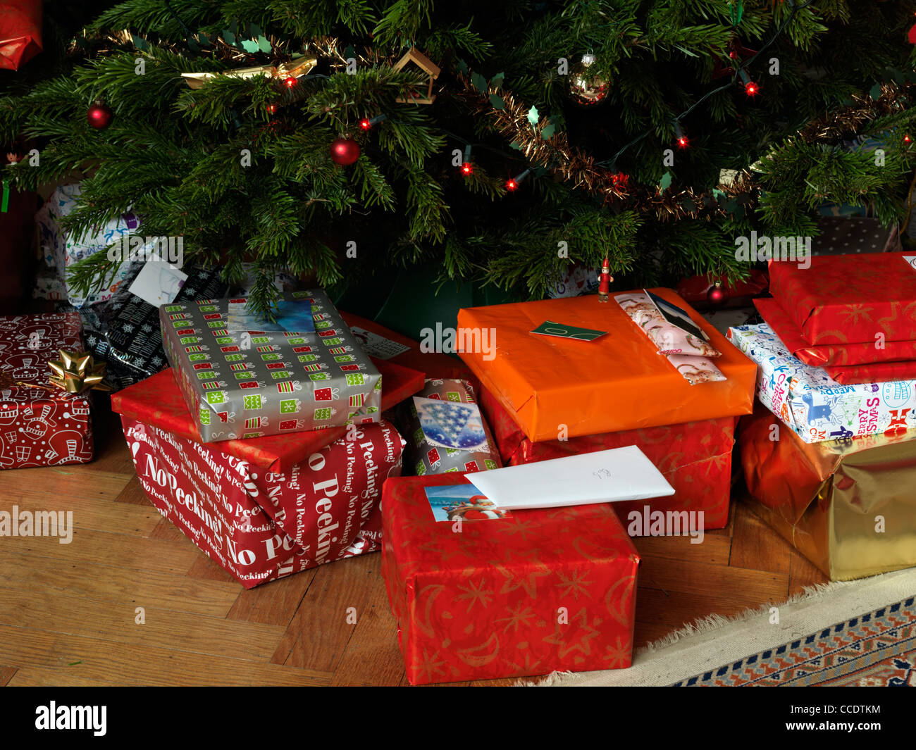 Wrapped Presents Under The Christmas Tree Stock Photo - Alamy