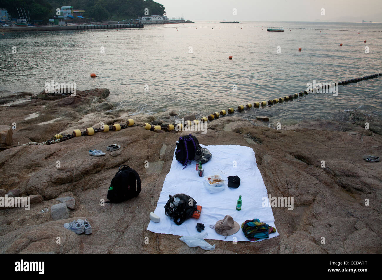 Abandoned belongings and clothes on a beach towel on St Stephens Beach ...