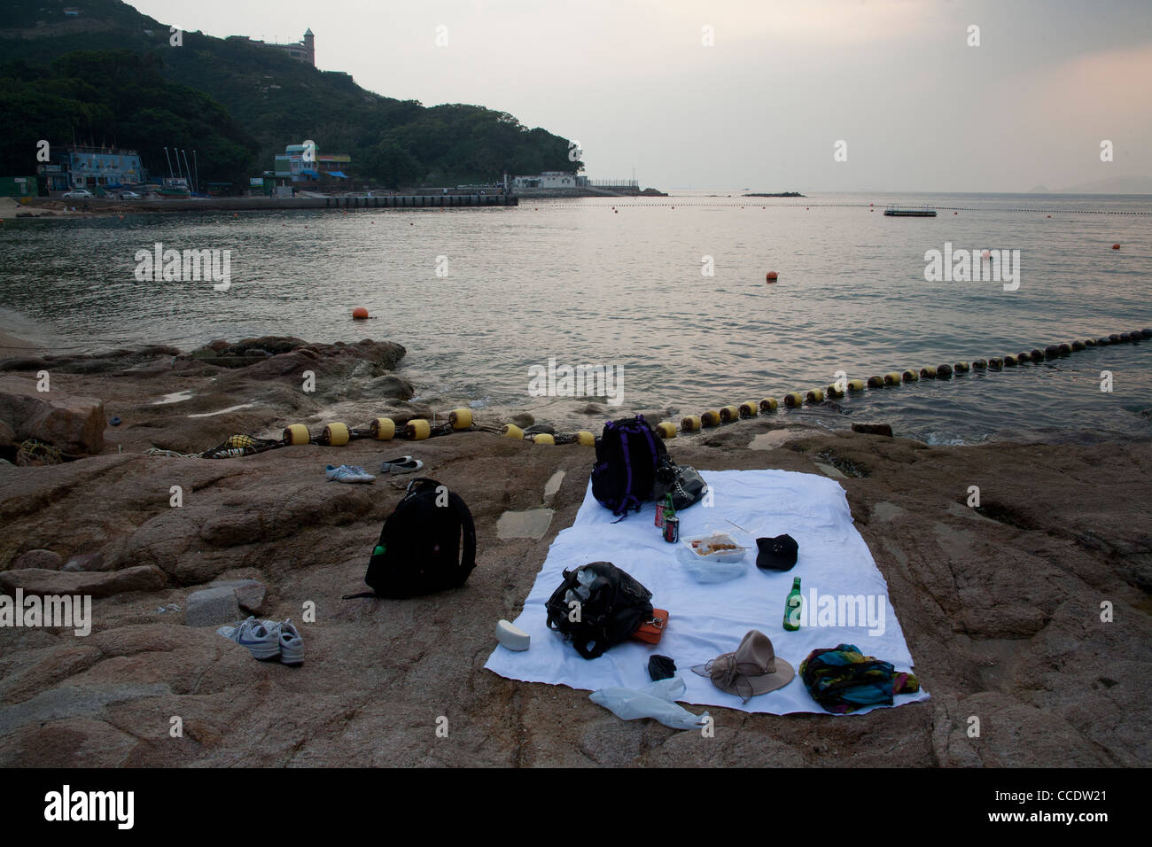 Abandoned belongings and clothes on a beach towel on St Stephens Beach ...