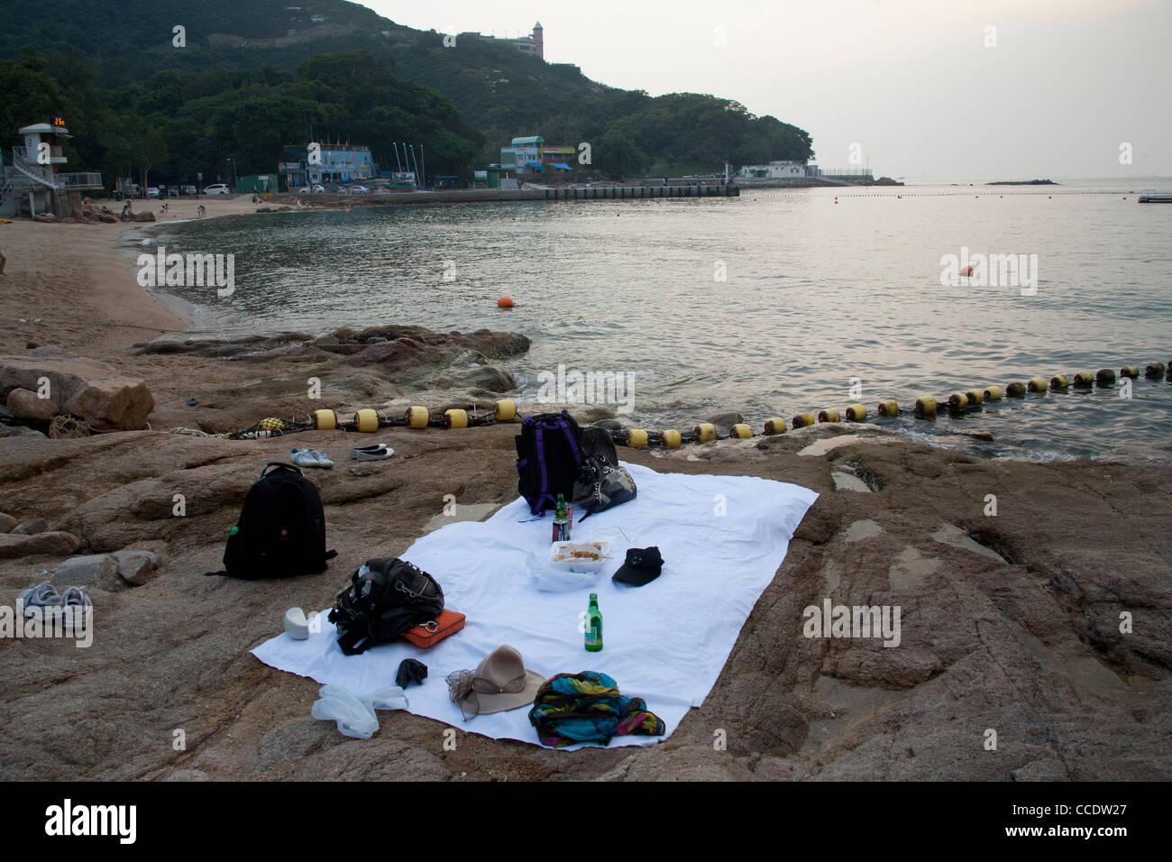 Abandoned belongings and clothes on a beach towel on St Stephens Beach ...