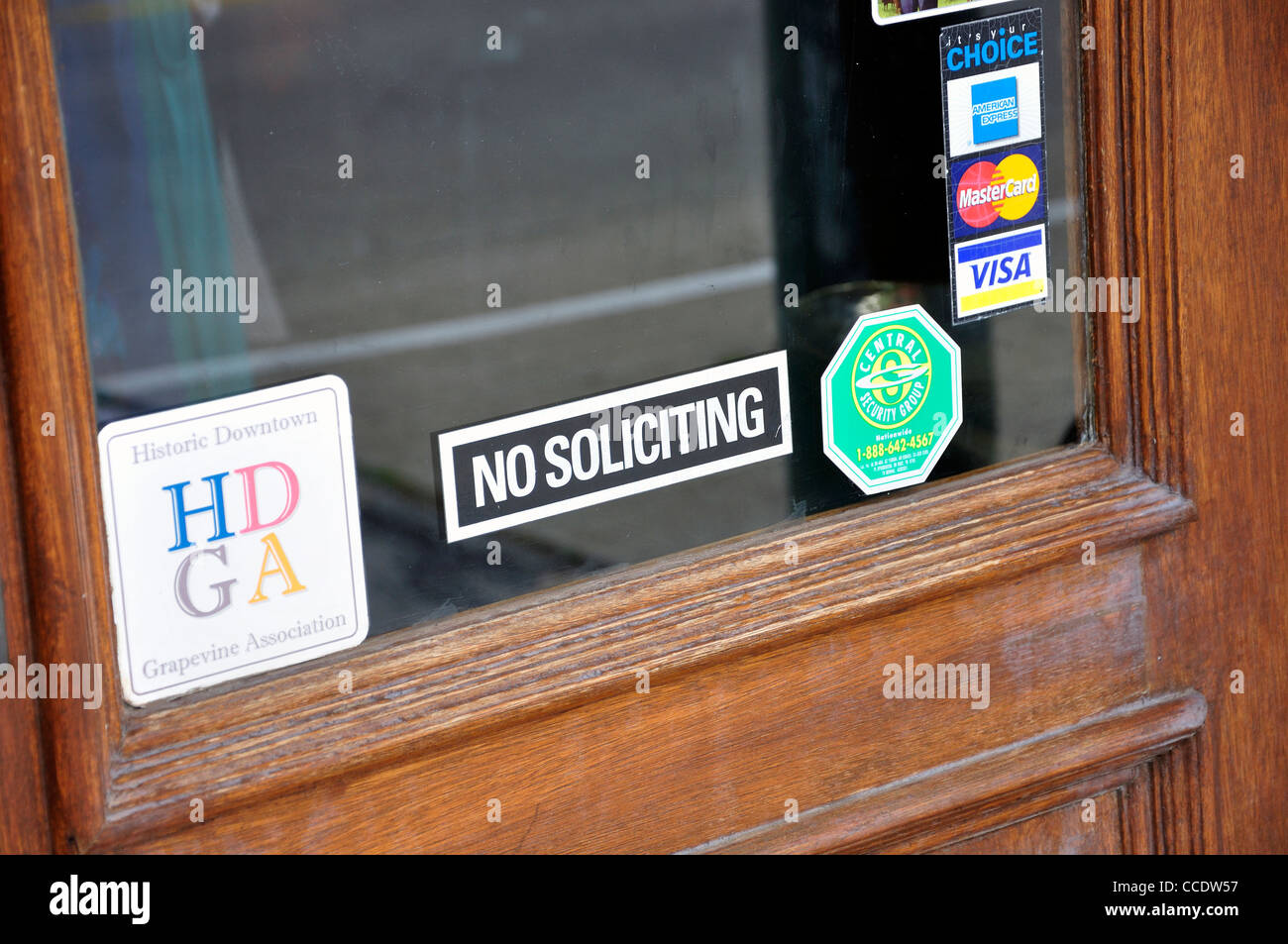 Store door with No Soliciting sign and payment accepted options signs ...