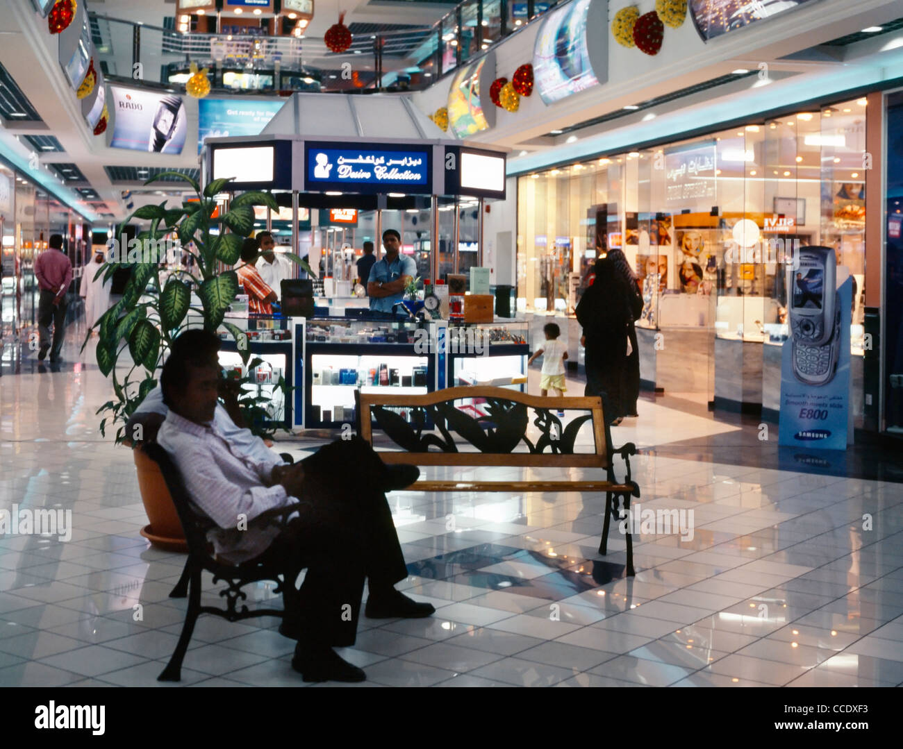 Dubai UAE Dubai Airport Duty Free Men Sitting On Bench Stock Photo - Alamy