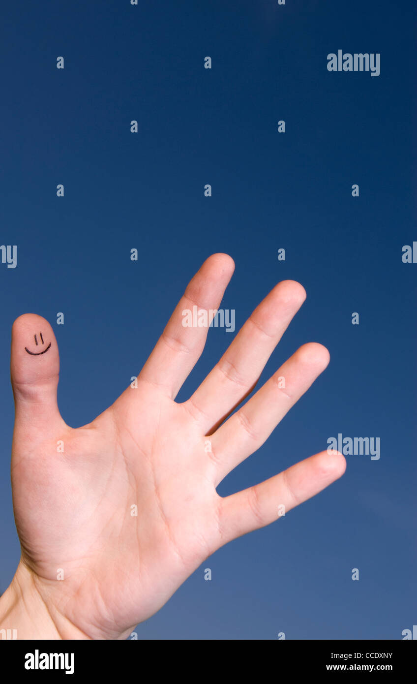 Open palm with a smiley painted on a thumb :D Stock Photo - Alamy