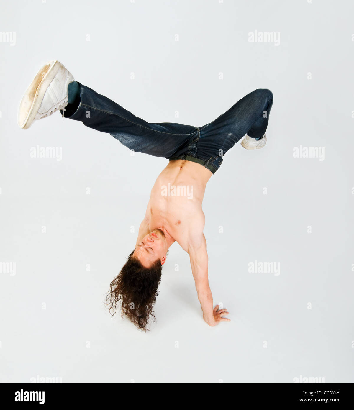 Young man performing a handstand on white background Stock Photo - Alamy
