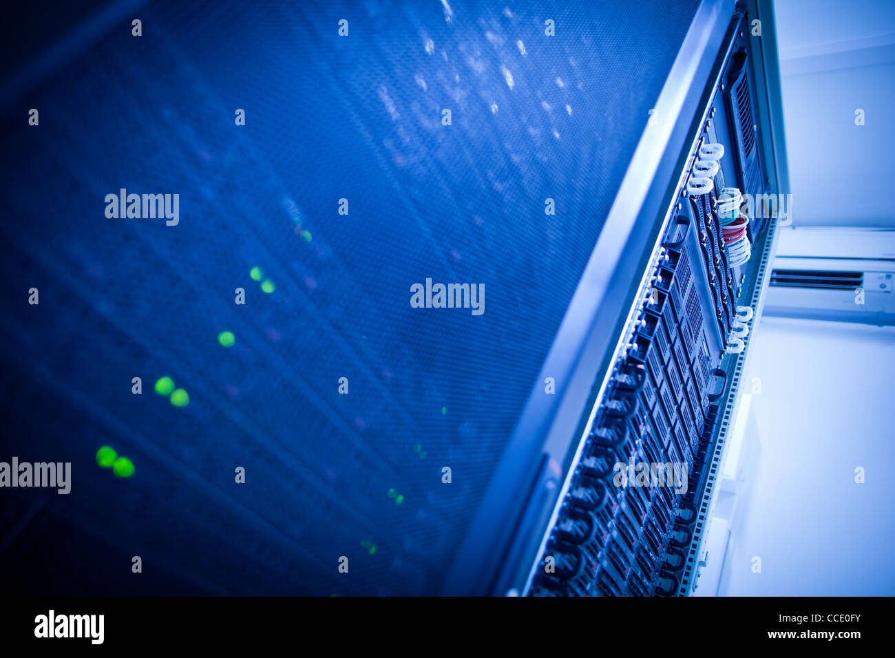 Server rack cluster in a data center (shallow DOF; color toned image ...