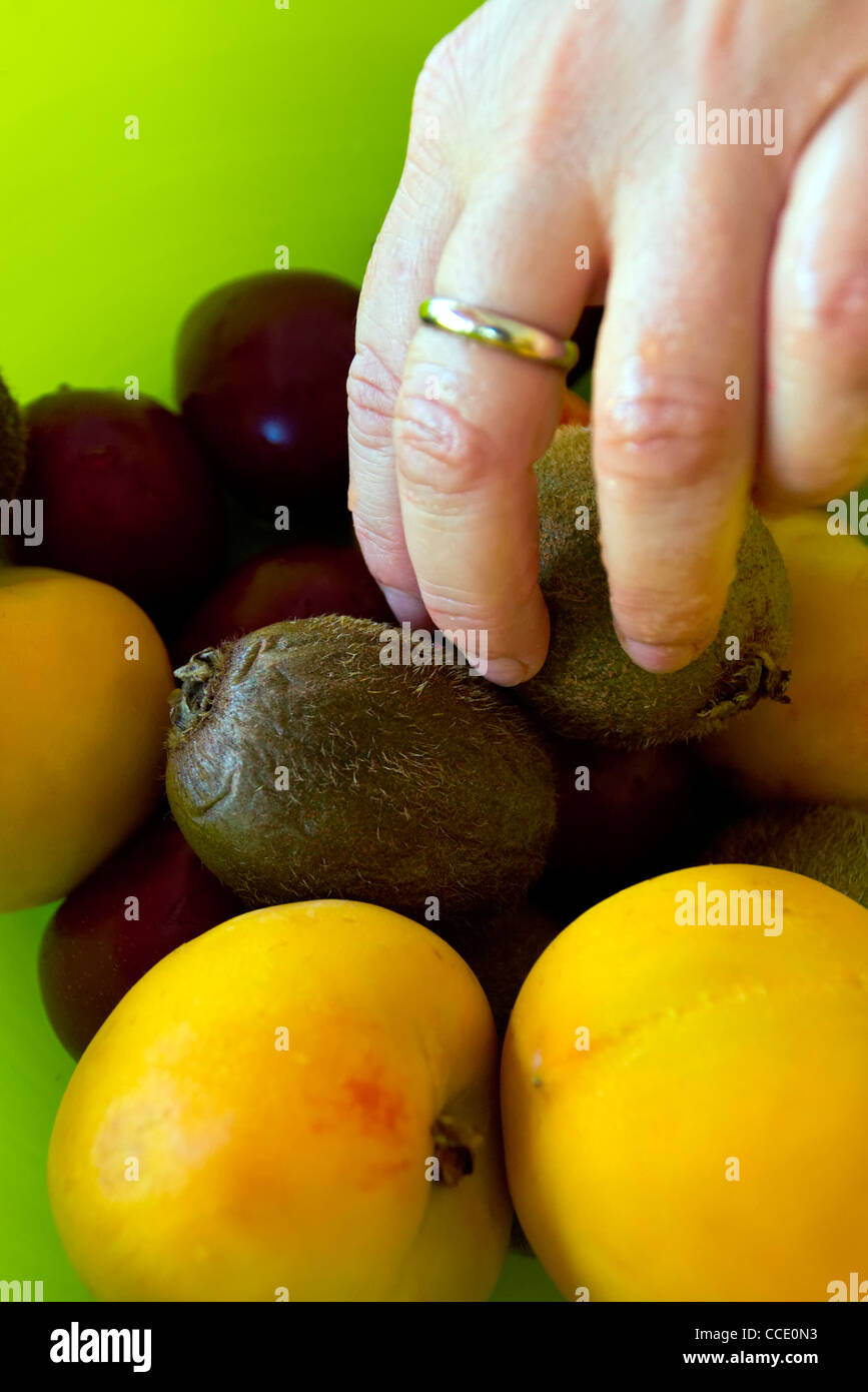 Hand picking up some fruit Stock Photo - Alamy