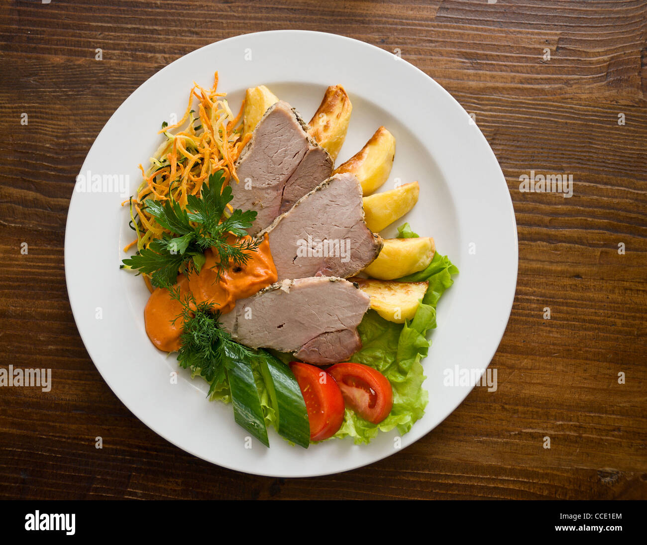 Tasty meat dish on wooden table background Stock Photo - Alamy
