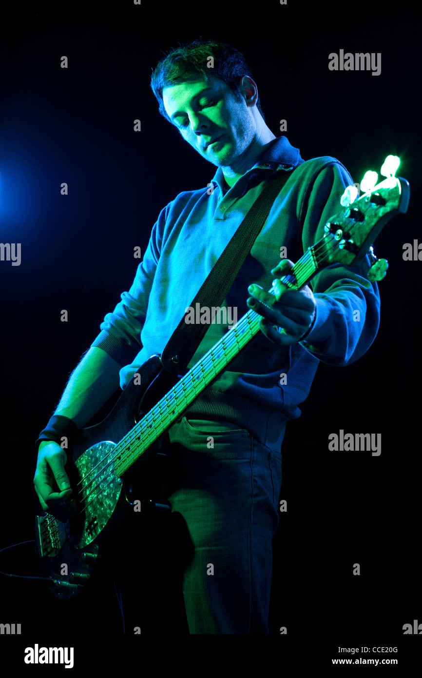 Man Playing Electric Bass on Black Background Stock Photo - Alamy