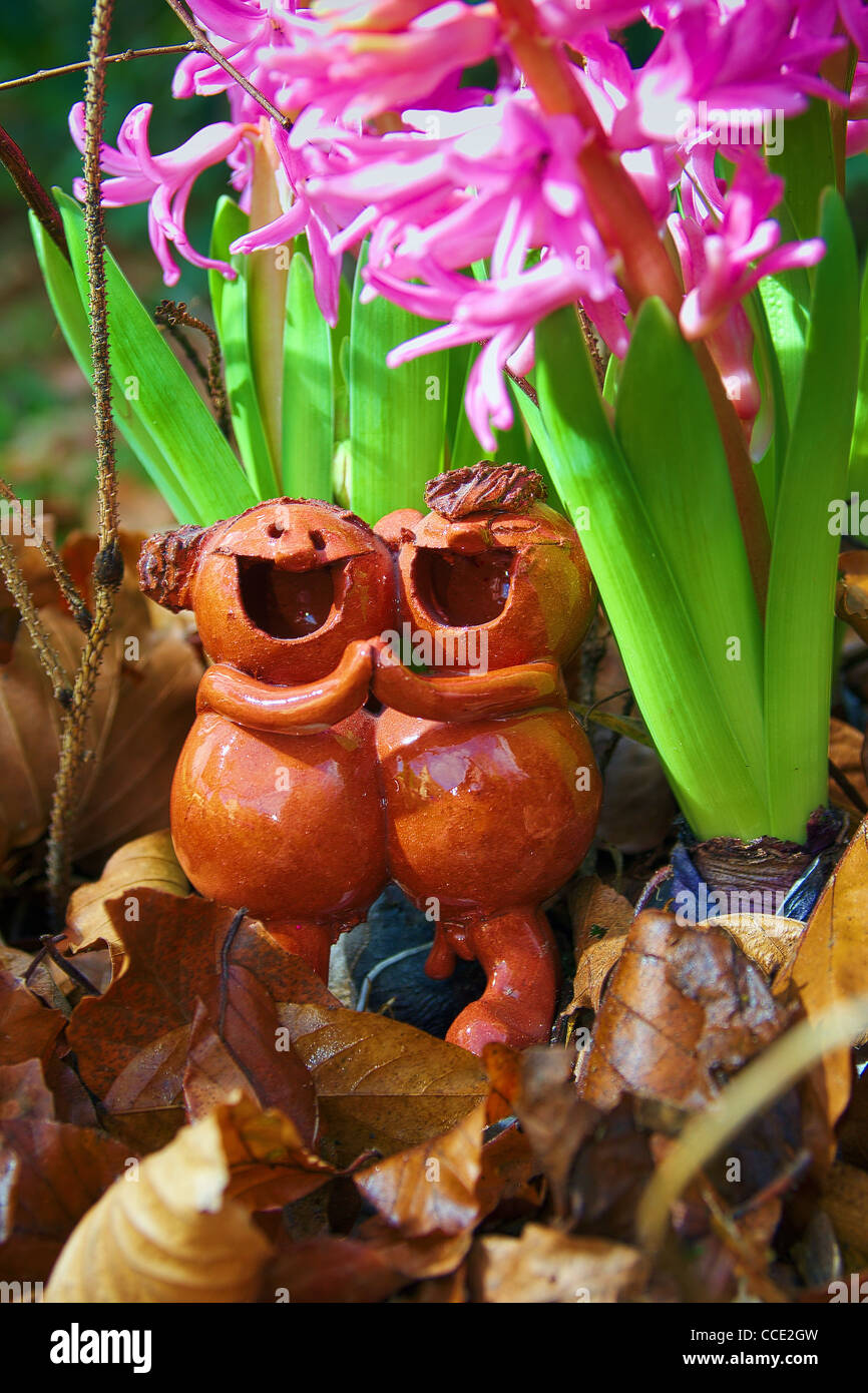 Adam and Eve in Spring Paradise with pink flowers Stock Photo - Alamy