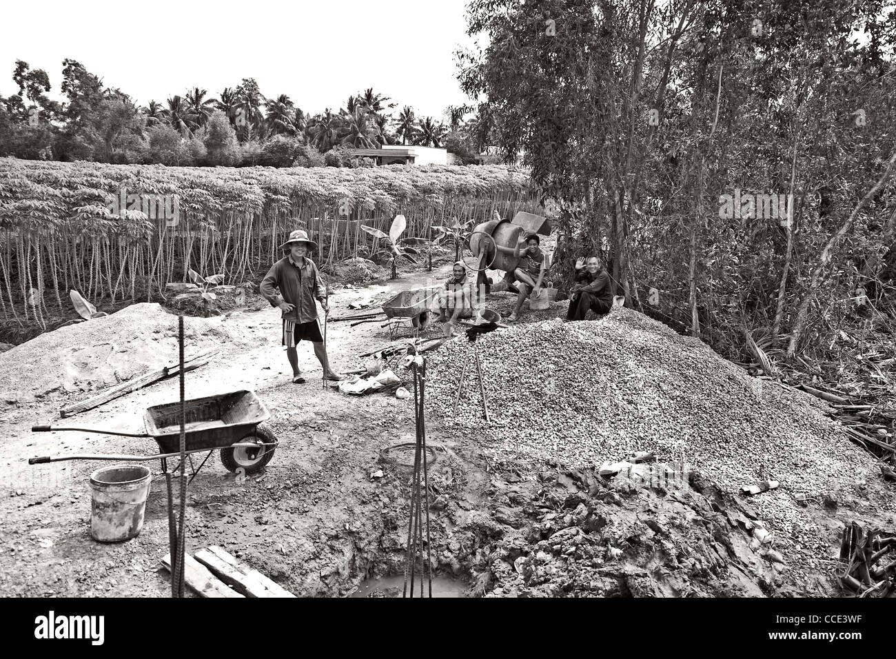 Vietnamese construction workers building a bridge over the Mekong Delta ...