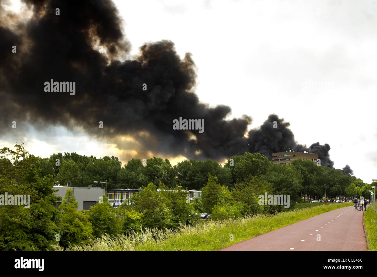 Black smoke from burning rubber going over the city - in a big fire a ...