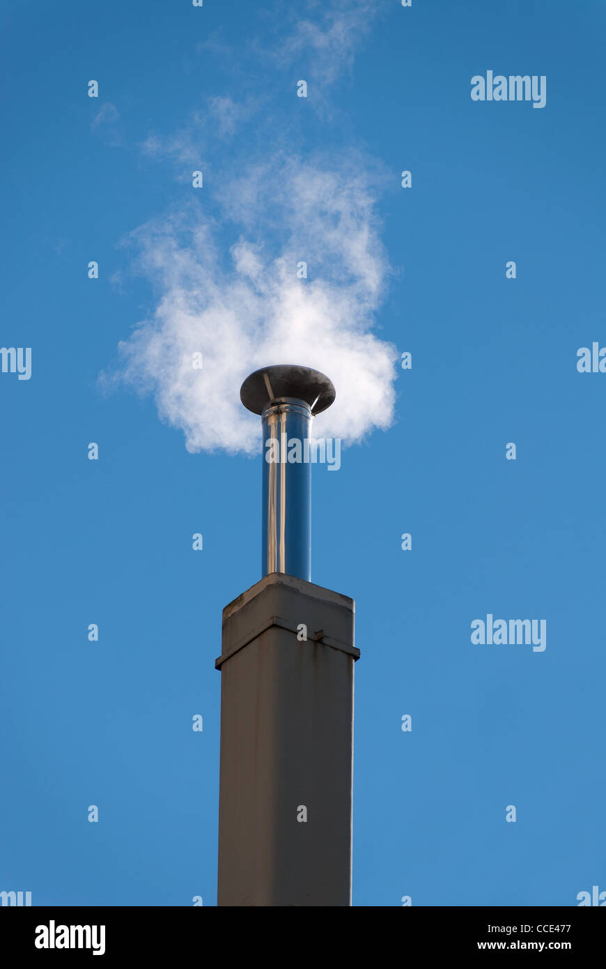 chimney with smoke illuminated by the sun Stock Photo - Alamy