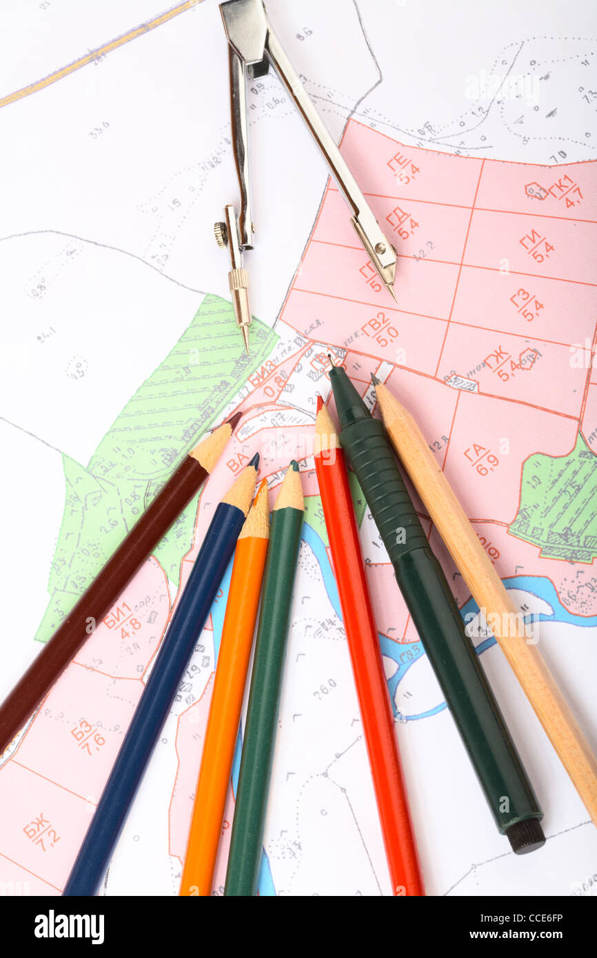 Topographic map of district with a measuring instrument and pencils ...