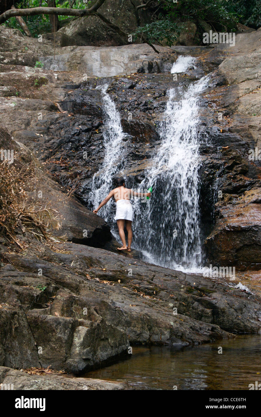 Value of Water.A Man collecting drinking water from forest waterfalls ...