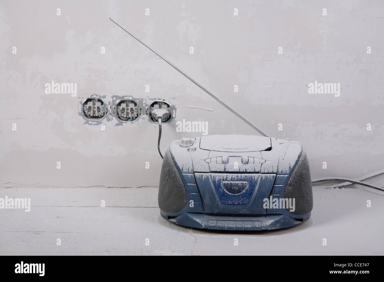 Repair of a room. A radio receiver in a dust on a background of a grey ...