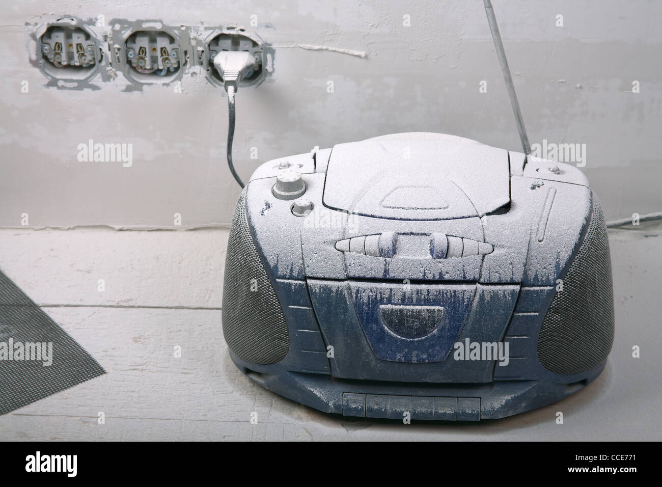 Repair of a room. A radio receiver in a dust on a background of a grey ...