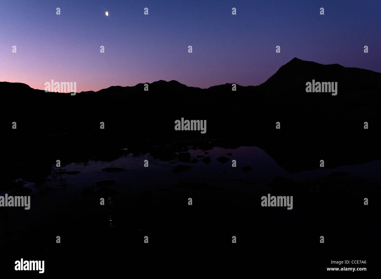 The skyline and reflection of Crib Goch from Llyn Cwmffynnon Stock ...