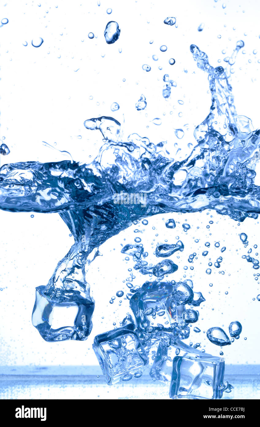 ice cubes dropped into water with splash on white Stock Photo - Alamy