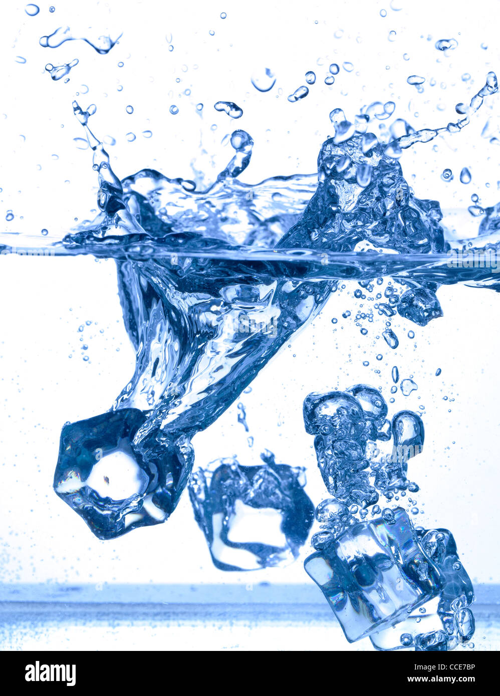 ice cubes dropped into water with splash on white Stock Photo - Alamy