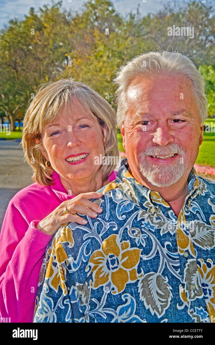 A middle aged married couple pose in afternoon sun in a Long Beach, CA ...