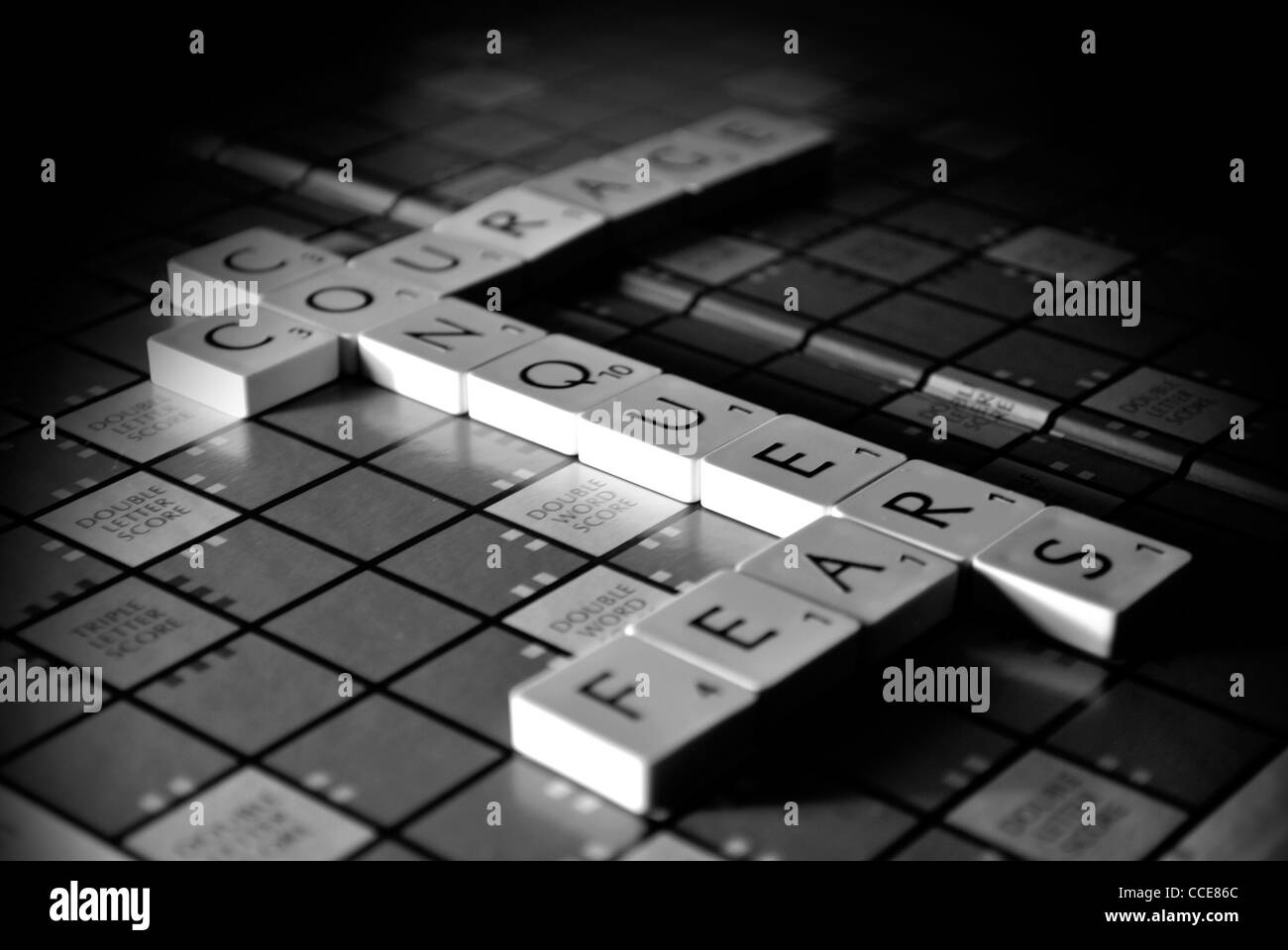 Scrabble motivational message Courage Conquers Fear Stock Photo - Alamy