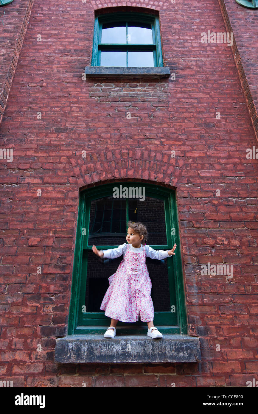 Young girl standing in window Stock Photo - Alamy