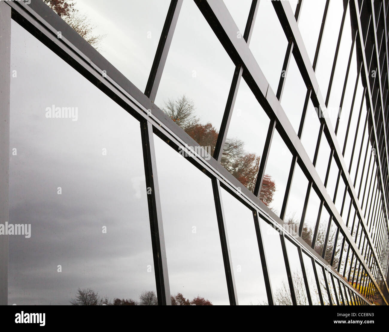 Angled glass wall bent inward reflecting trees and sky Stock Photo - Alamy