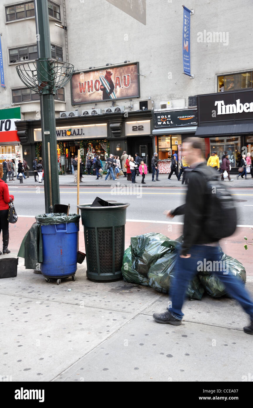 New York, USA - man walking past garbage bags Stock Photo - Alamy
