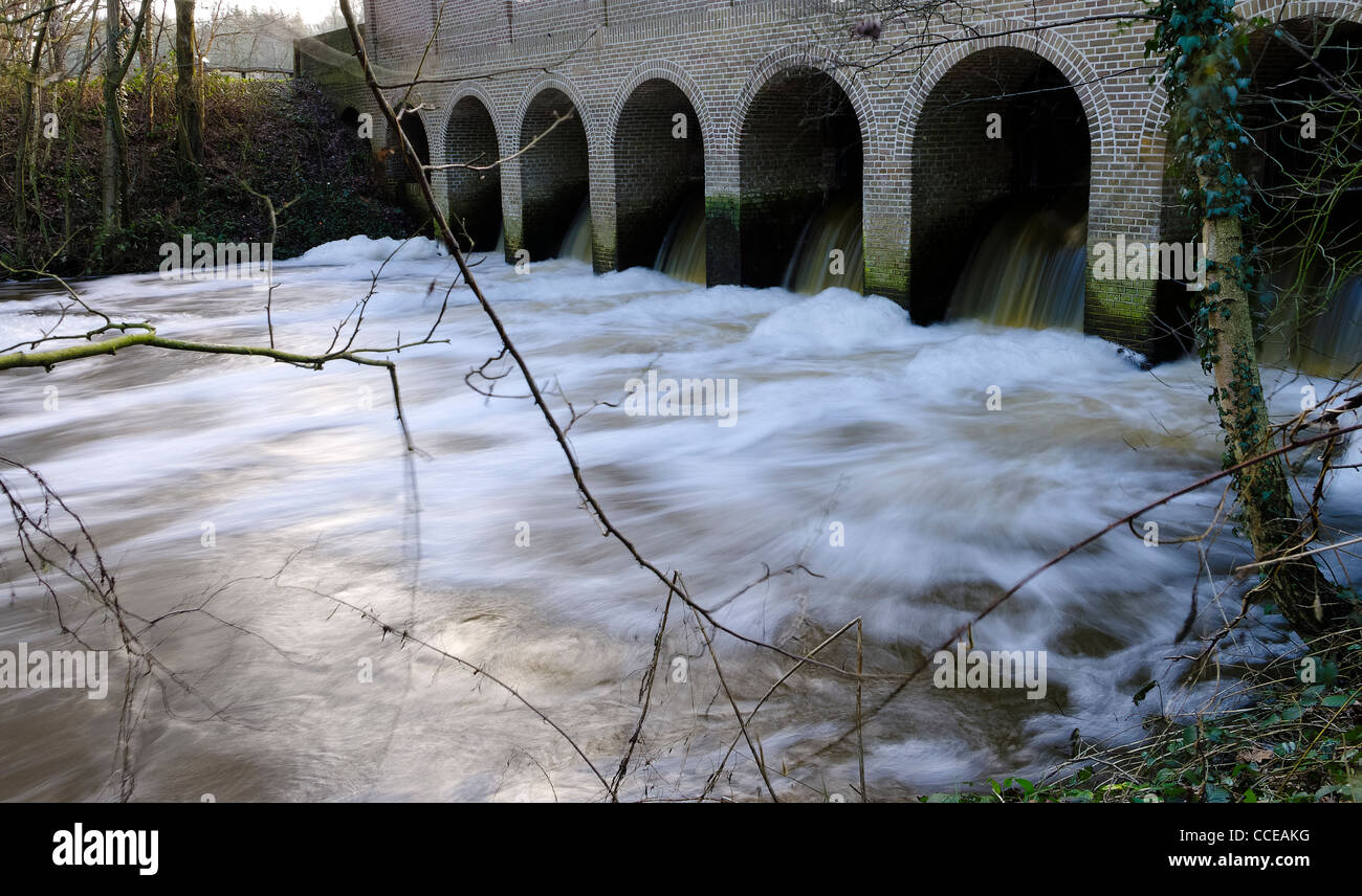 flowing water coming outside a historic sluice building Stock Photo - Alamy