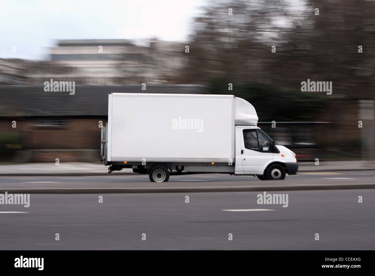 a white box van traveling along a road in London, England Stock Photo ...