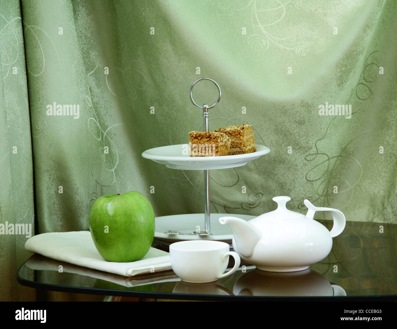 pretty cake stand with elegant china tea set Stock Photo - Alamy