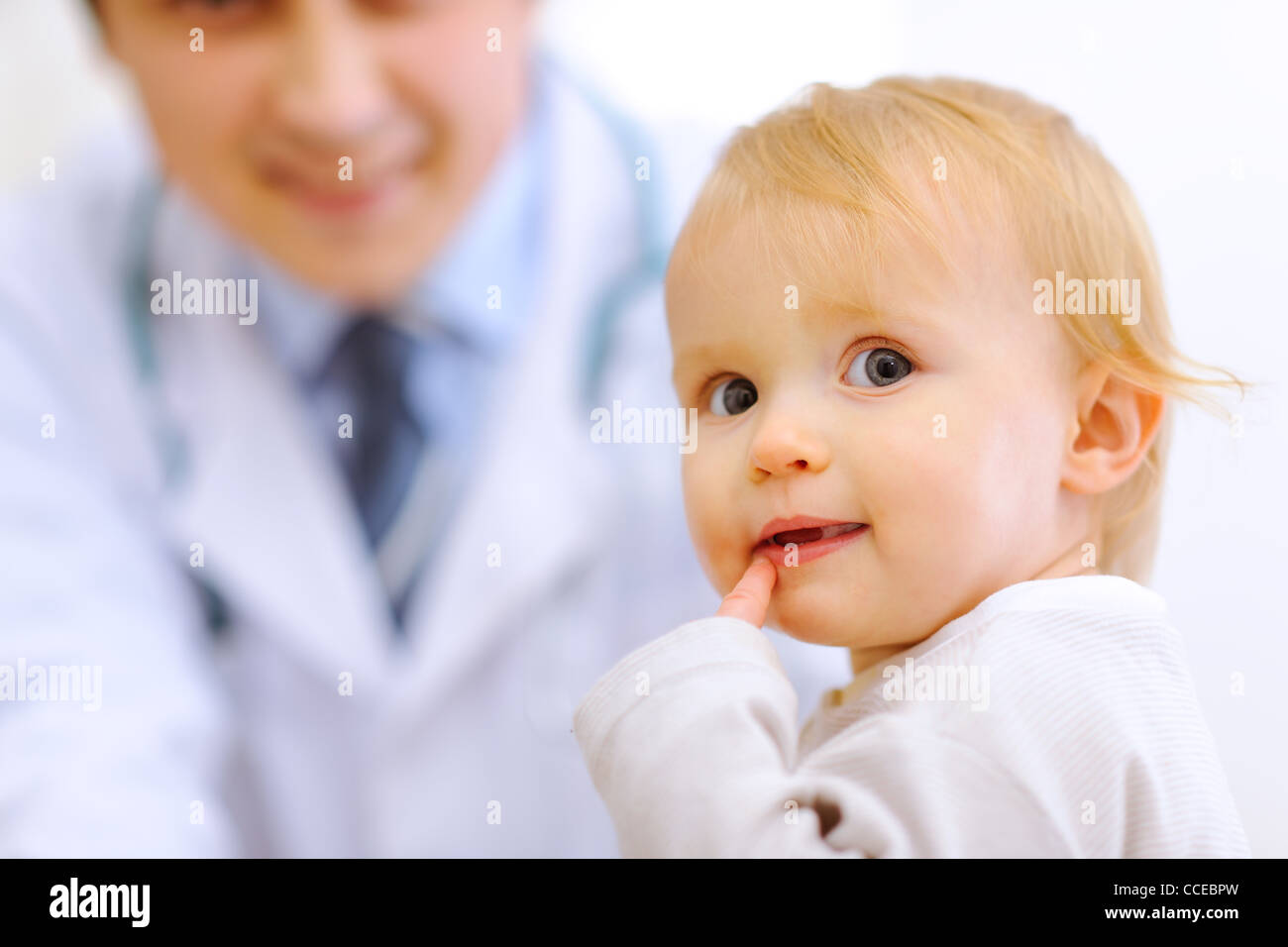 Portrait of baby and pediatrician doctor in background Stock Photo - Alamy